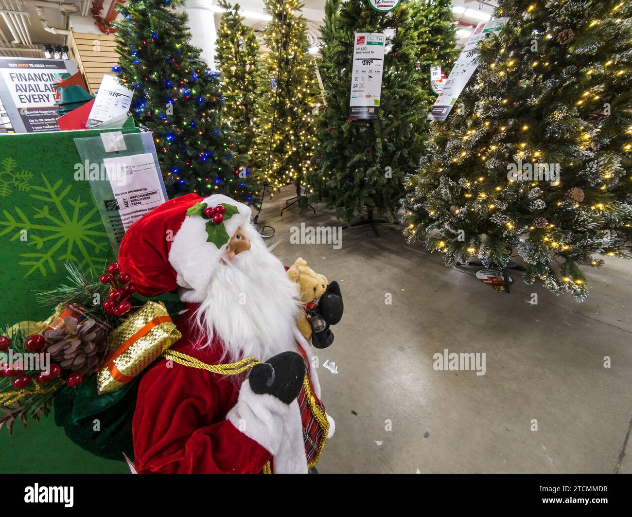 Santa Claus figurines guard the Christmas trees and decorations in a ...