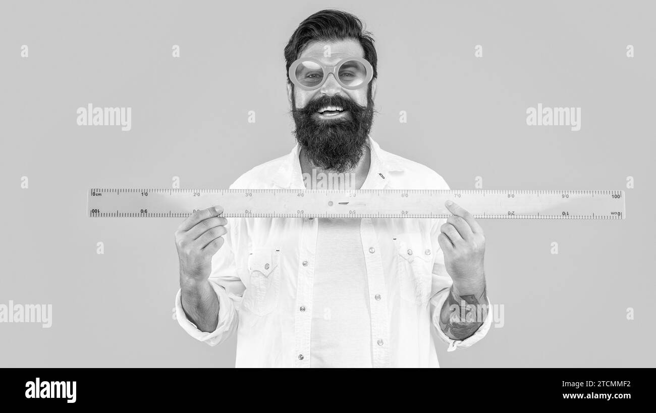 happy school man measure with ruler in studio. school man measure with ...
