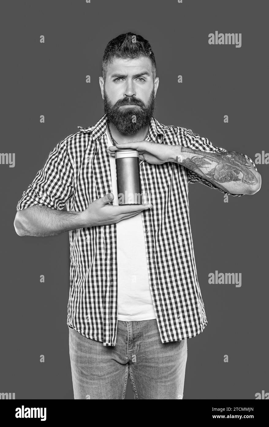 bearded guy presenting male product of beard care cosmetics Stock Photo ...