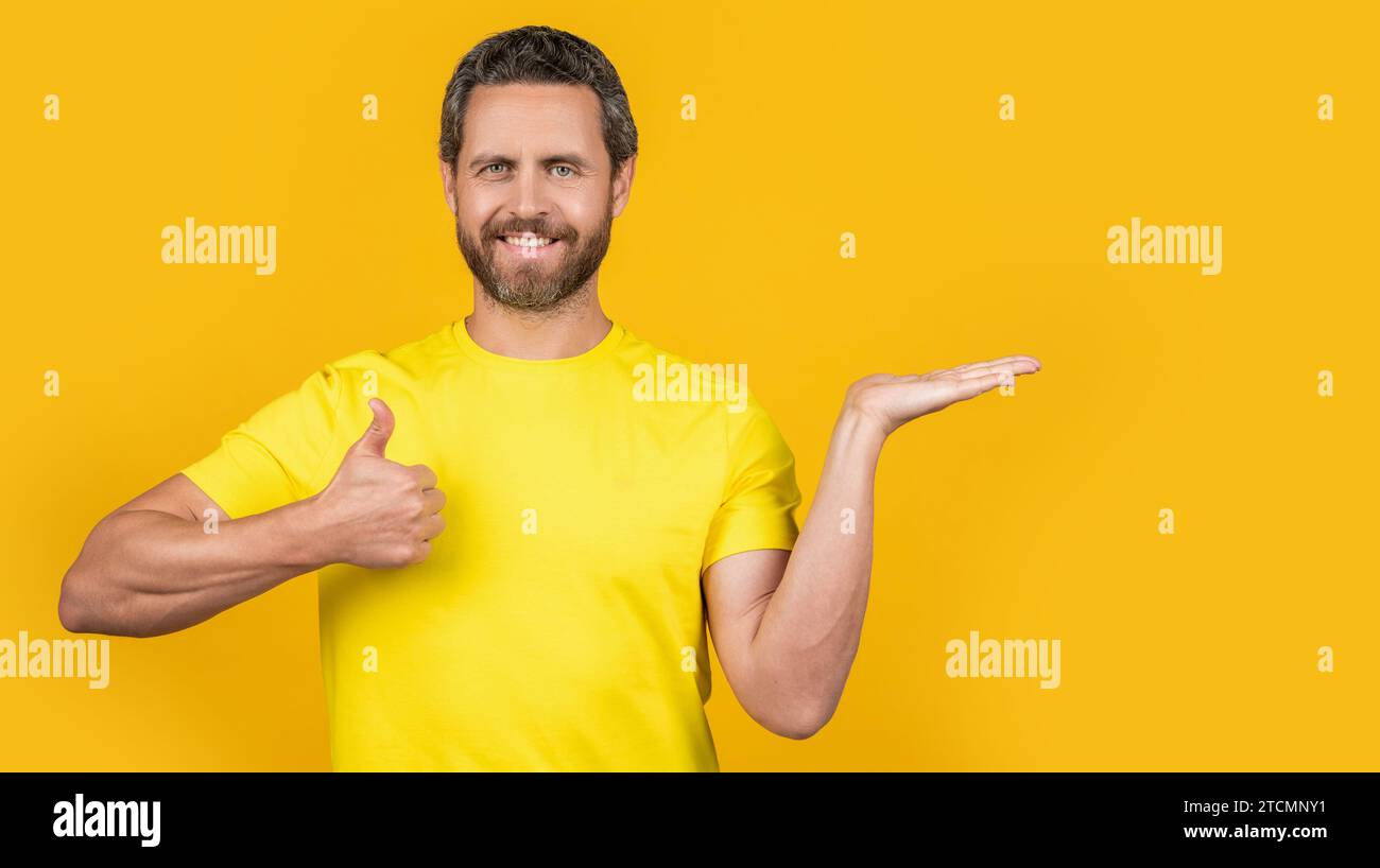 happy man presenting advertisement on background, thumb up. man ...