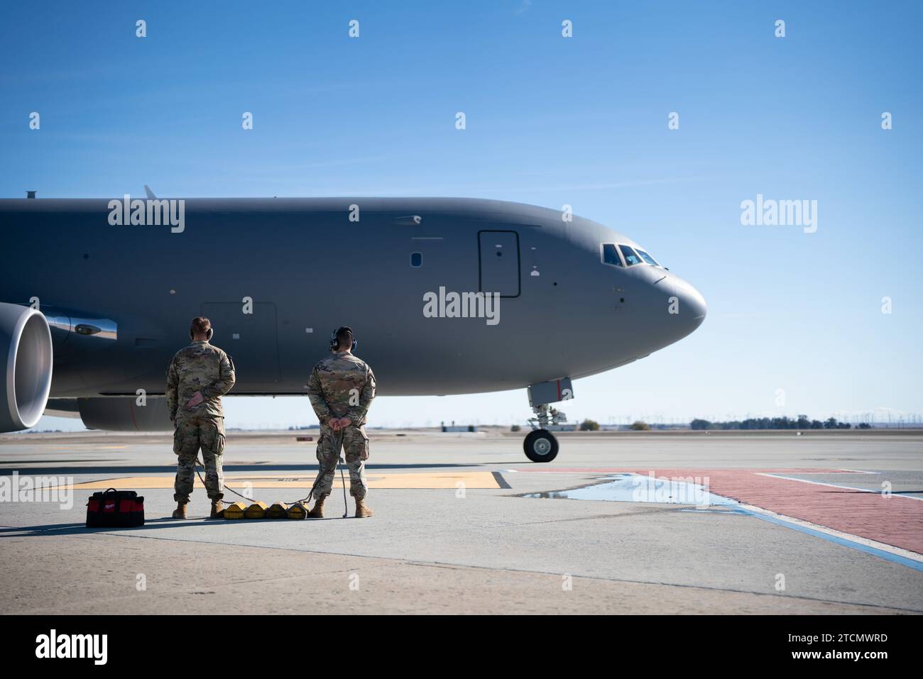 U.S. Airmen assigned to the 60th Air Mobility Wing stand by during the ...