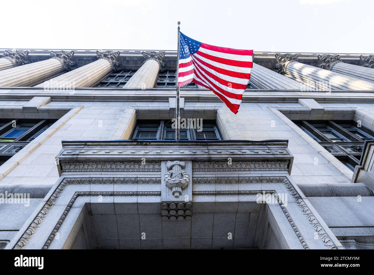A vibrant American flag waving in the wind on the exterior of a ...