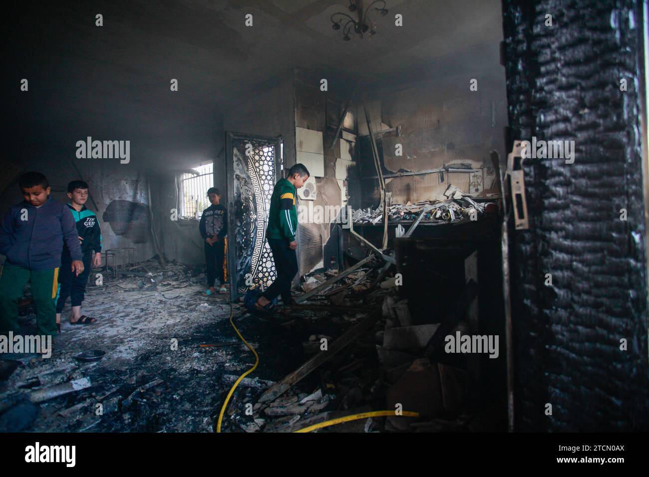 Jenin, Palestine. 13th Dec, 2023. Palestinian inspect the damage inside ...