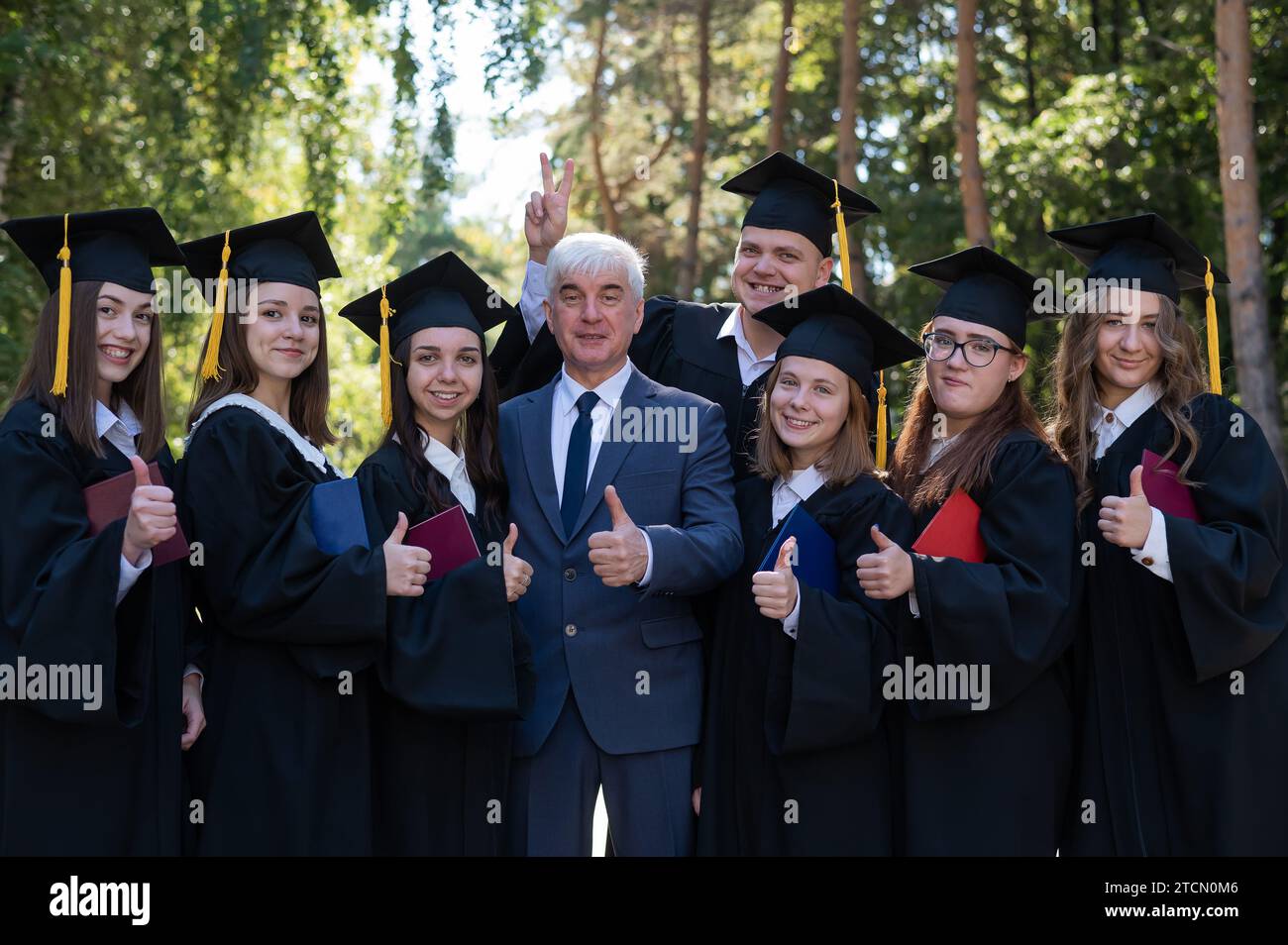 University professor and seven students rejoice at graduation and show ...