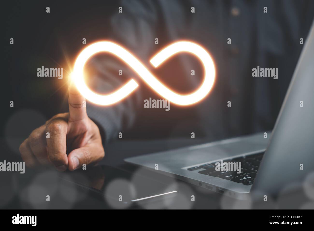 Businessman points to infinity symbol, representing limitless ...