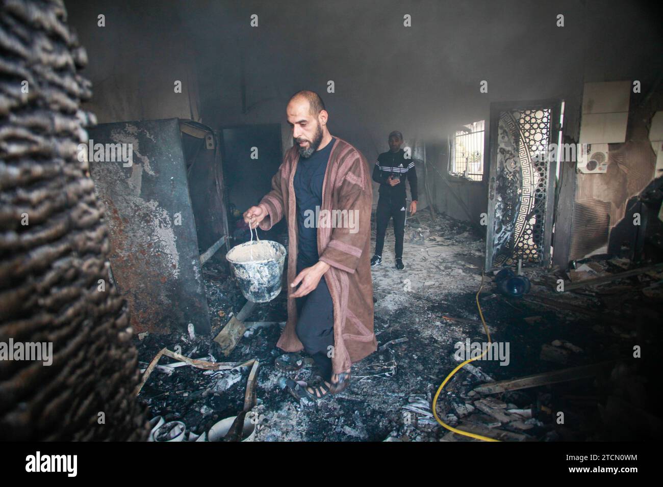 Jenin, Palestine. 13th Dec, 2023. Palestinian inspect the damage inside ...