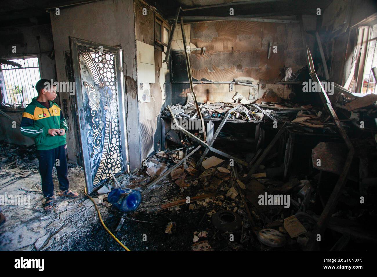 Jenin, Palestine. 13th Dec, 2023. Palestinian inspects the damage ...