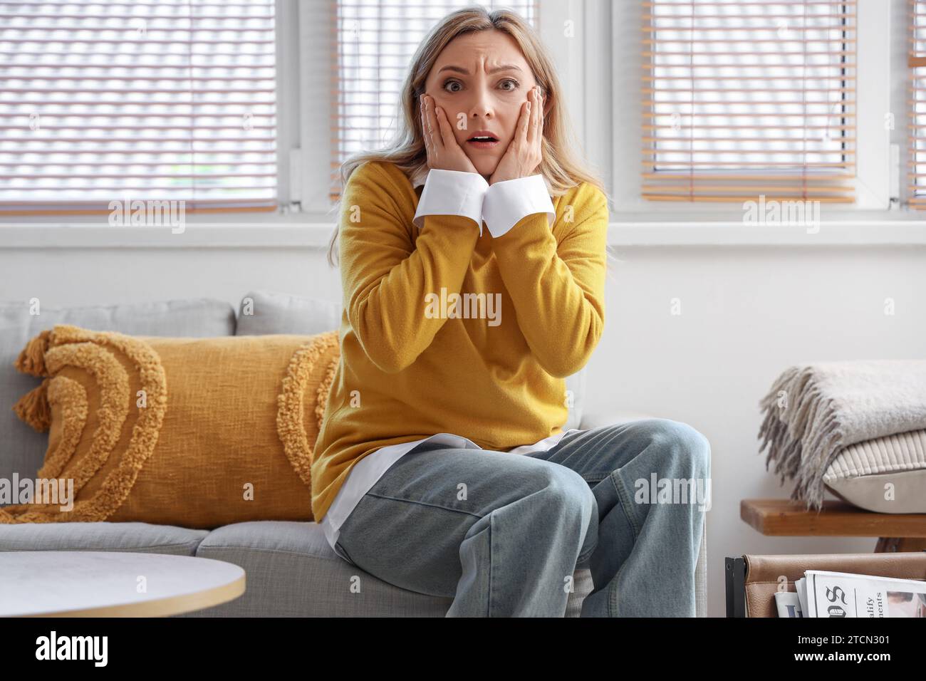 Scared mature woman at home Stock Photo - Alamy