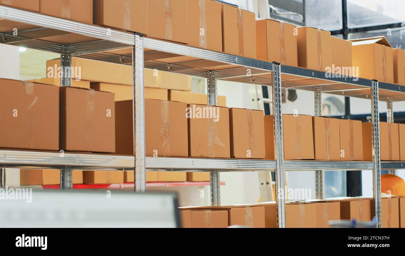 Empty warehouse with computer and cardboard boxes on racks, products ...