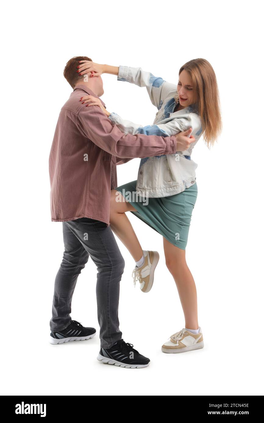 Young woman defending herself on white background Stock Photo - Alamy