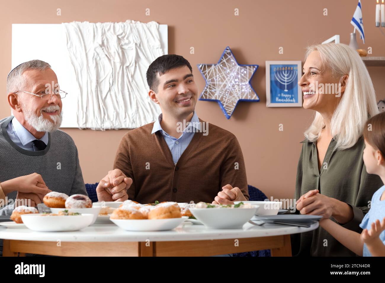Happy Jewish family having dinner at home on Hanukkah Stock Photo - Alamy