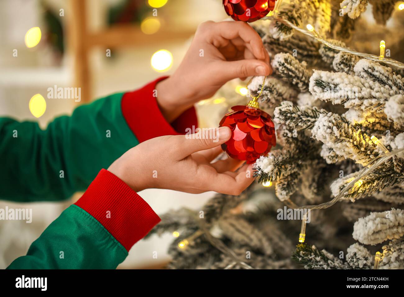 Little elf decorating Christmas tree at home Stock Photo - Alamy