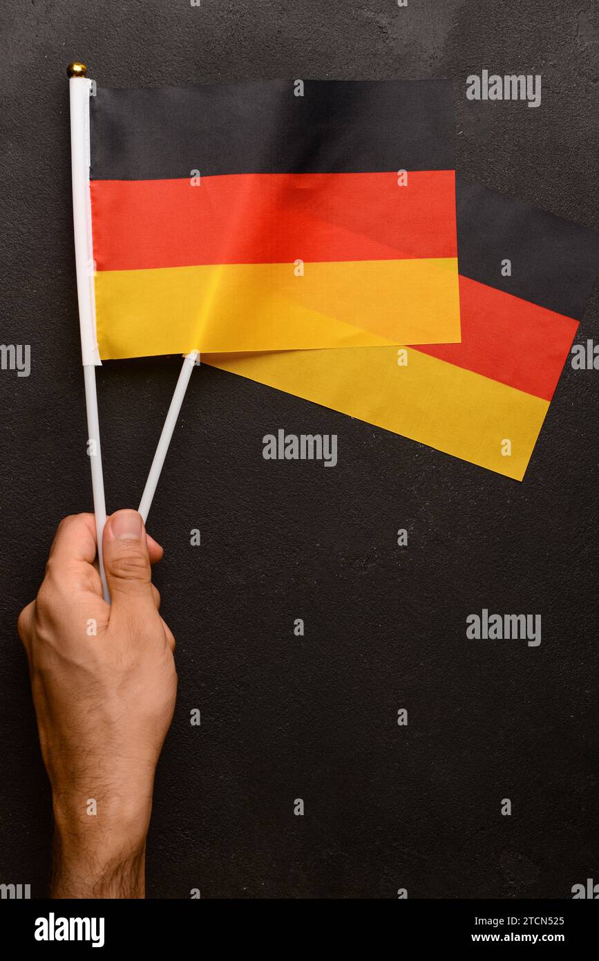 Male hand with flags of Germany on black background Stock Photo - Alamy
