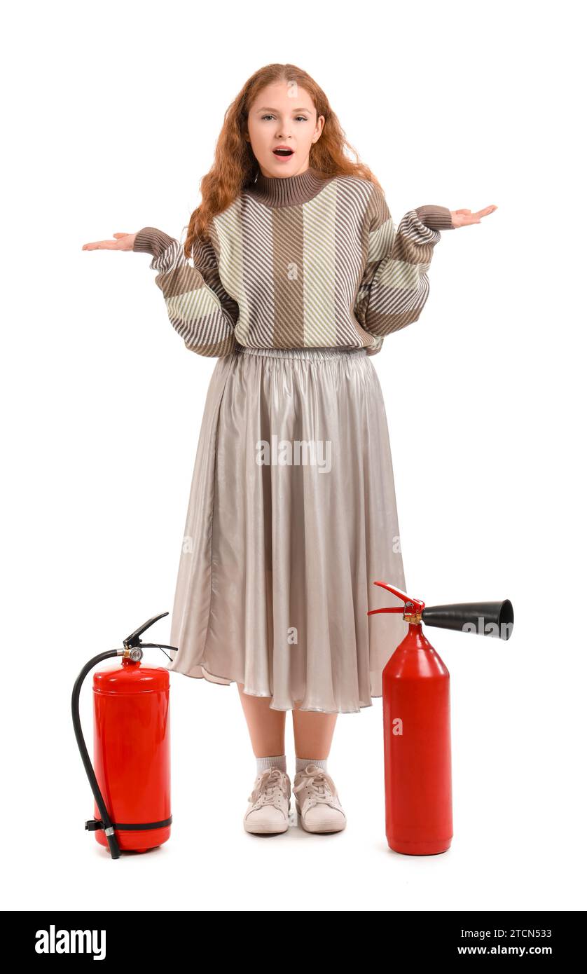 Confused young woman with fire extinguishers on white background Stock ...