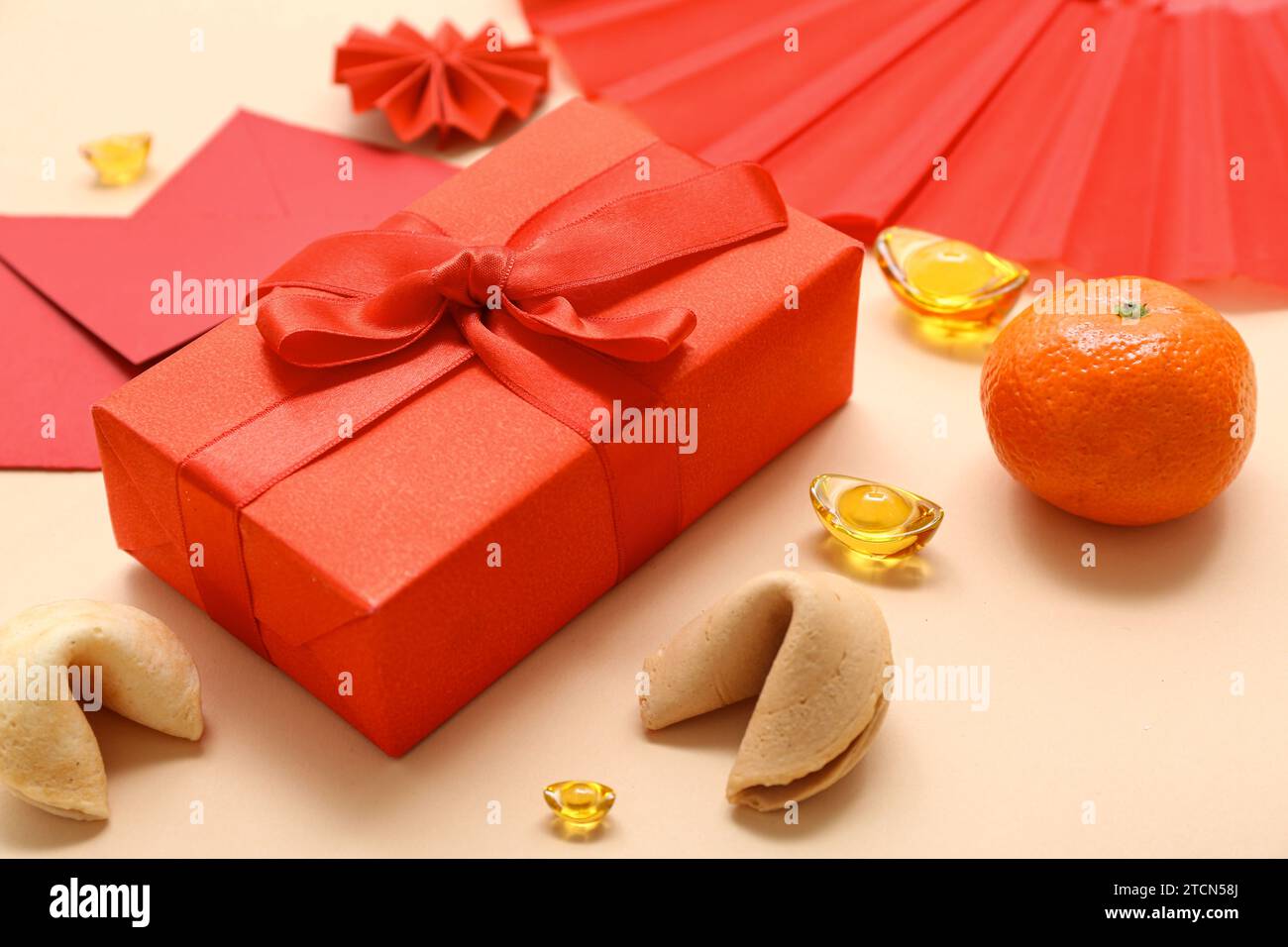 Gift box with mandarin, fortune cookies and Chinese symbols on beige ...