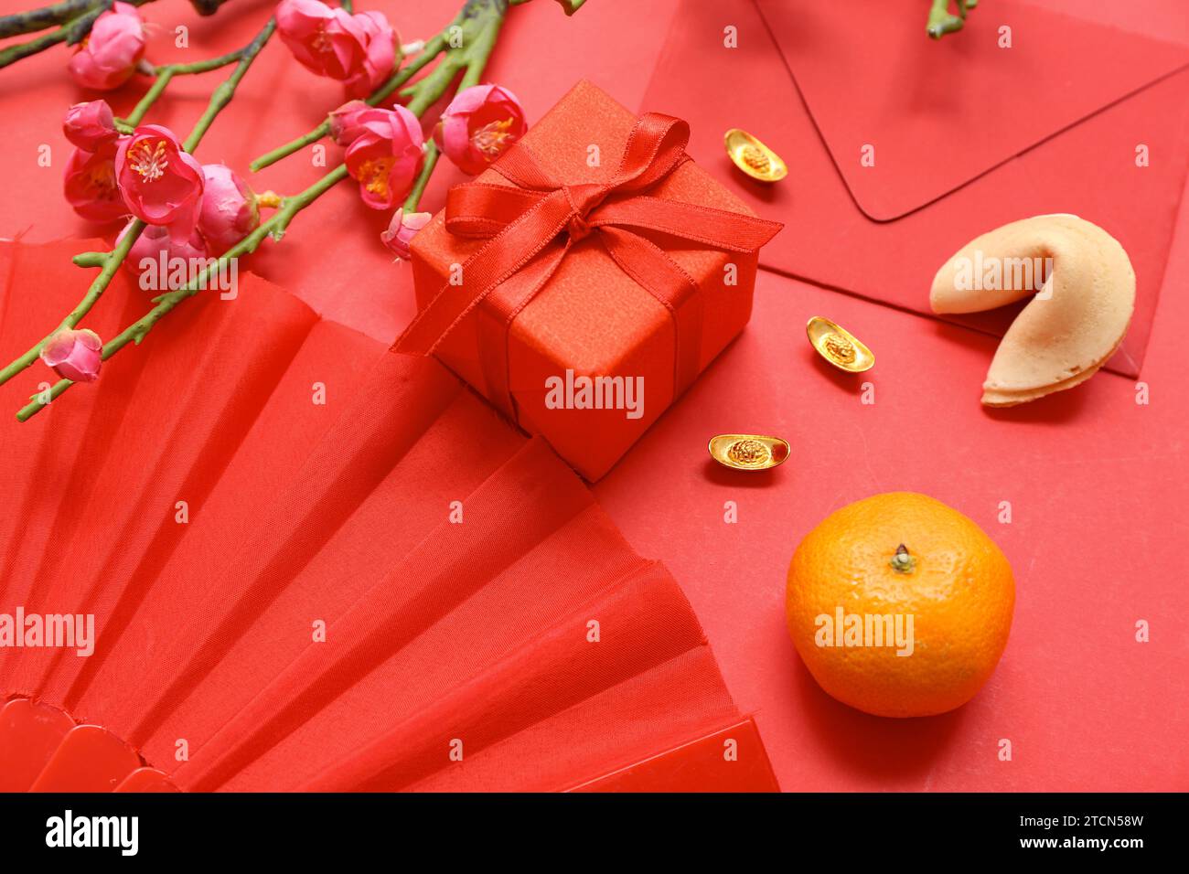 Gift box with fortune cookie, mandarin and Chinese symbols on red ...