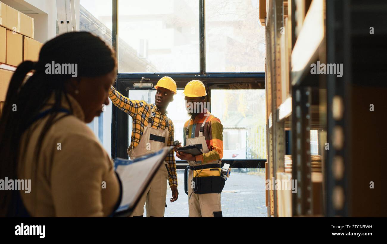 Team of men working on stock inventory in warehouse, scanning ...