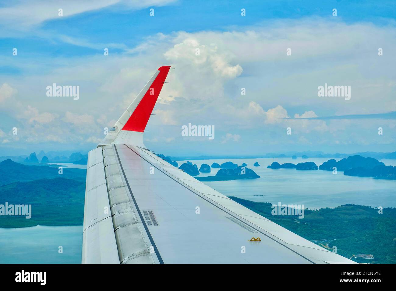 Wing of aeroplane over ocean island hi-res stock photography and images ...