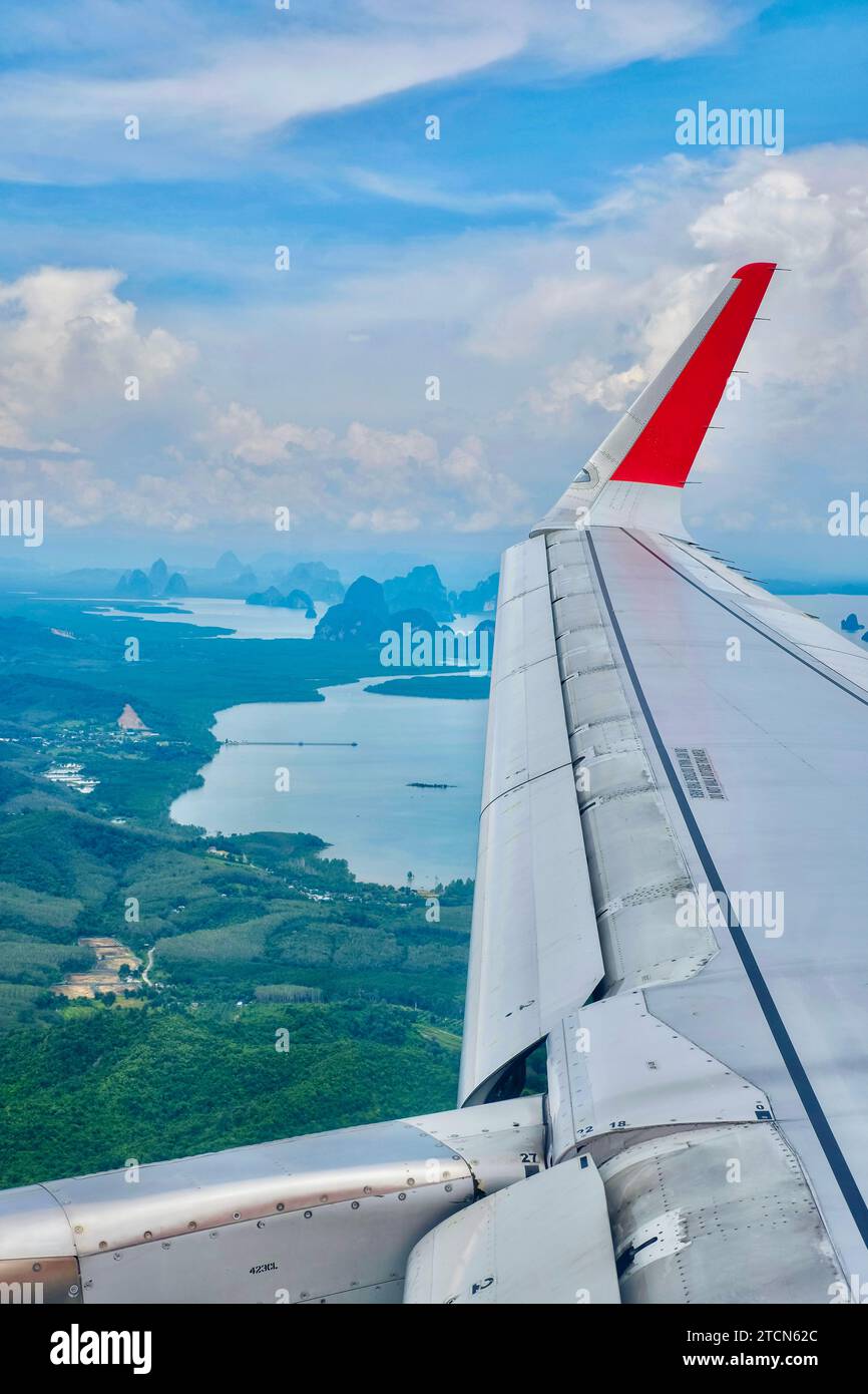 Wing of an aeroplane flying over Krabi, Phang Nga Bay and the islands ...