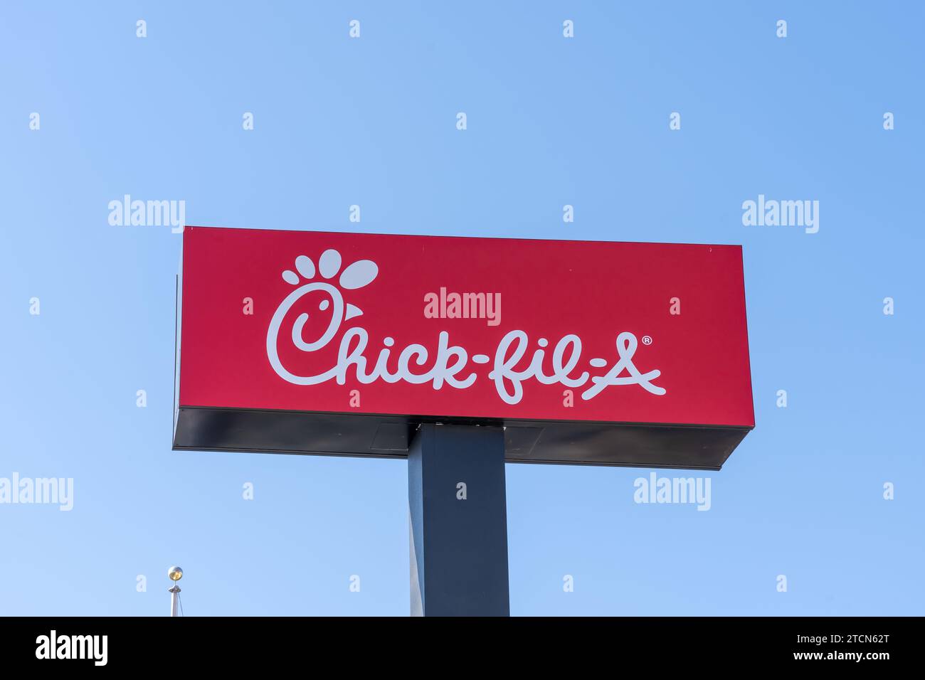 Close up of the Chick-fil-A logo sign with the blue sky in the ...