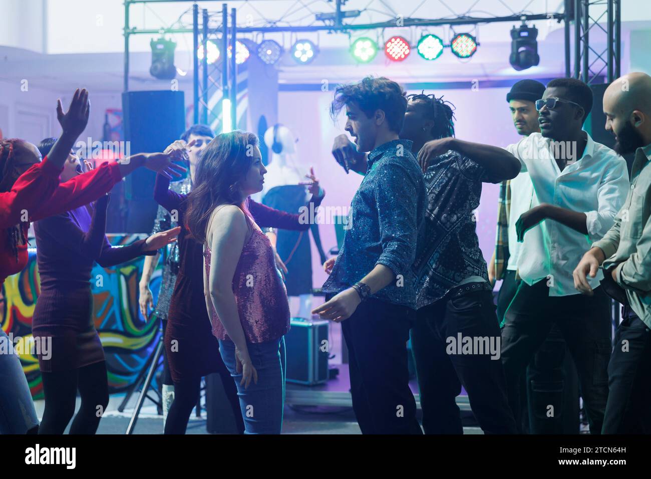 Passionate couple standing on crowded dancefloor ready for dance battle ...