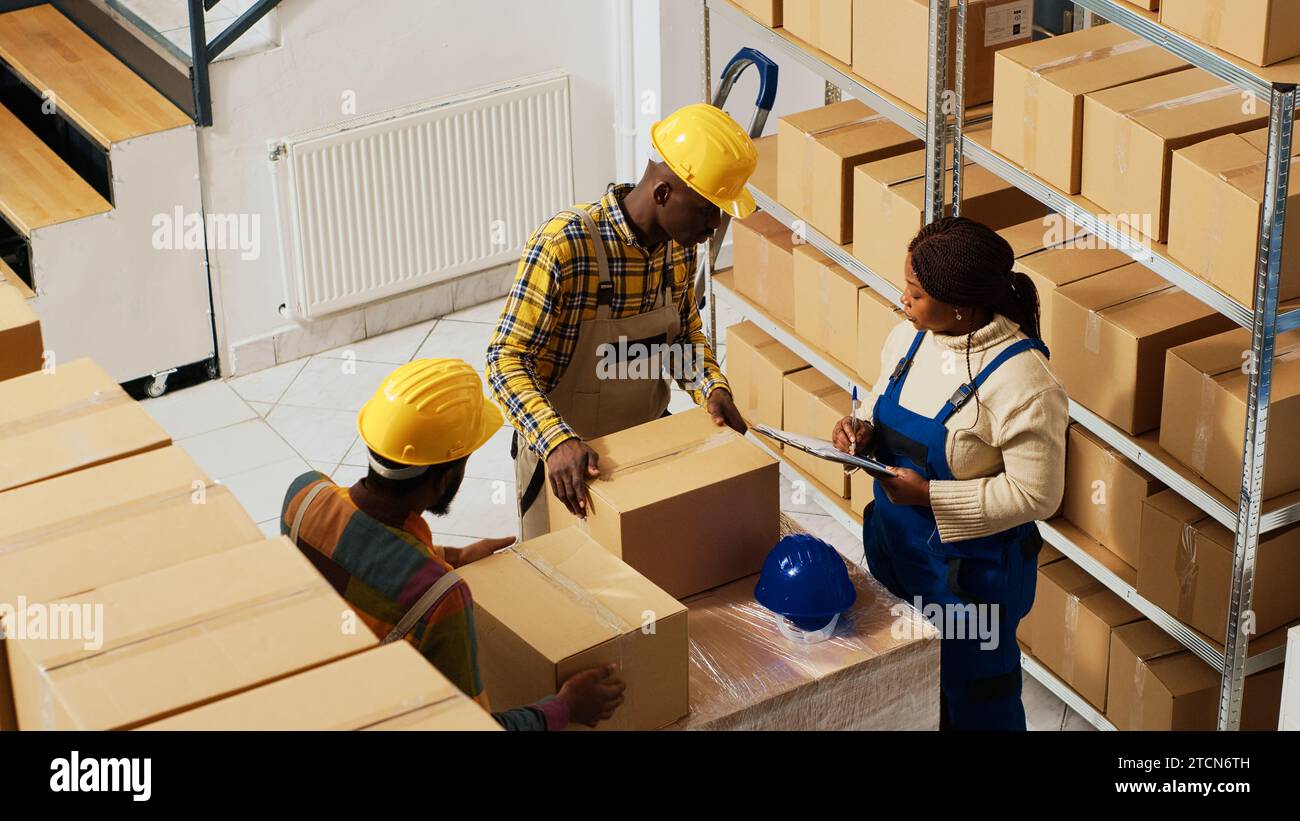 African american employees working on inventory and logistics, looking ...