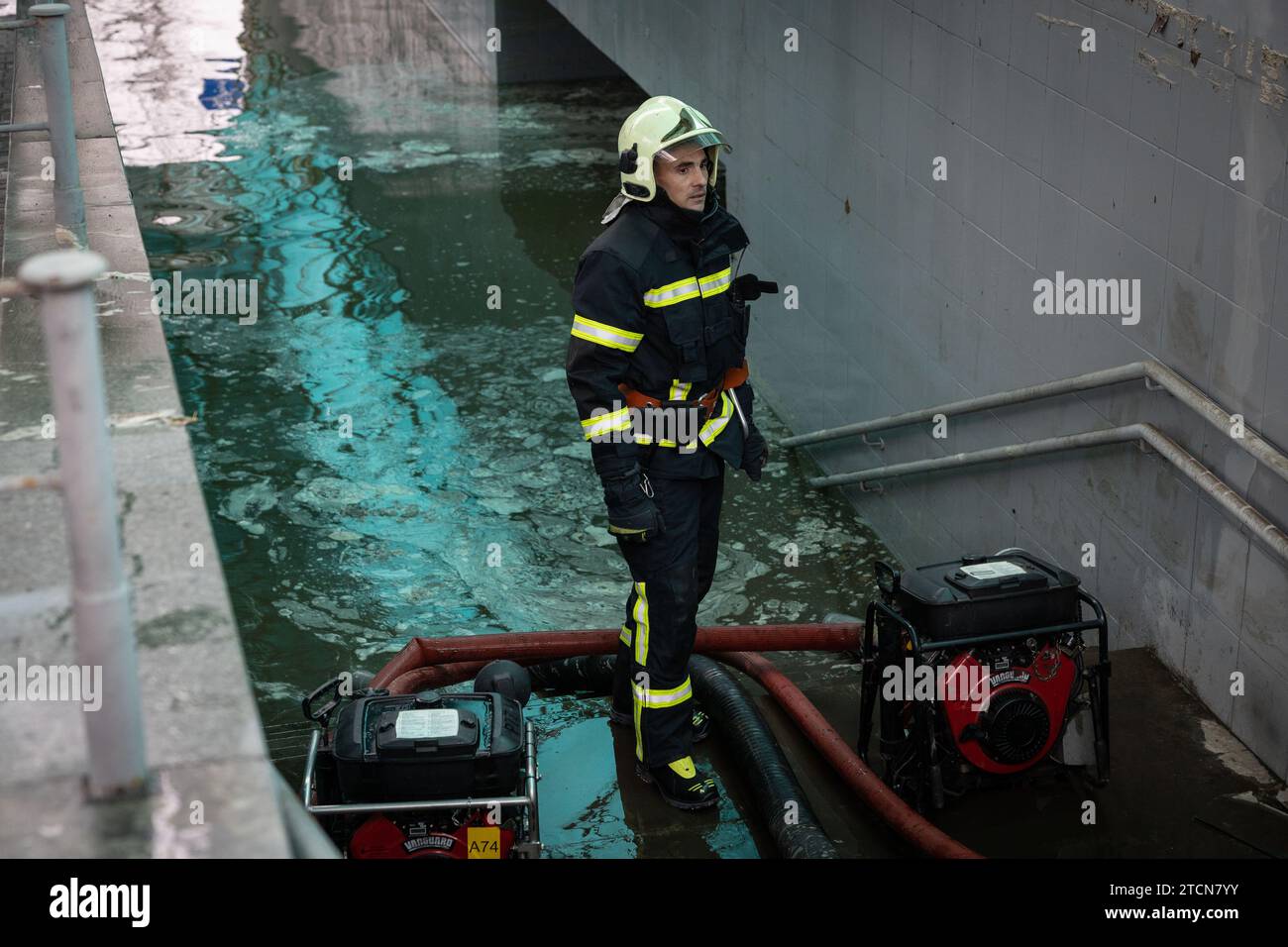 Kyiv, Ukraine. 13th Dec, 2023. A rescuer pumps water from an ...
