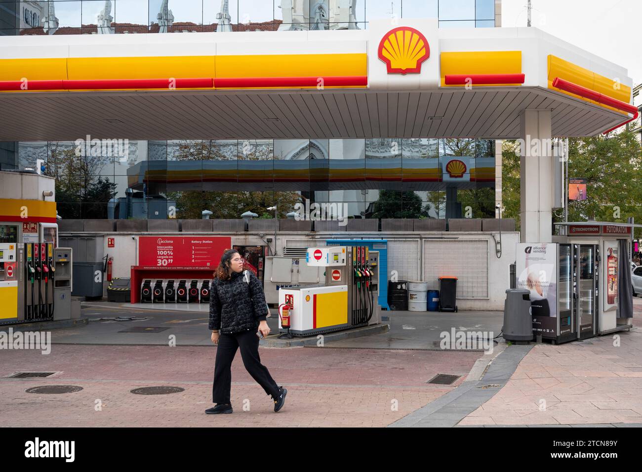 A woman walks past the Global group of energy and petrochemical ...