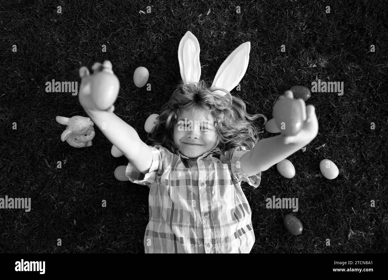 Child with rabbit ears, Easter holidays. Kid hunting Easter eggs. Cute ...