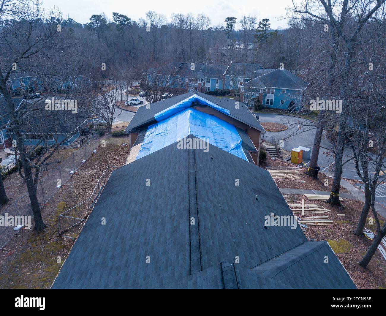 drone images of a fire damaged apartment building with a large tarp ...