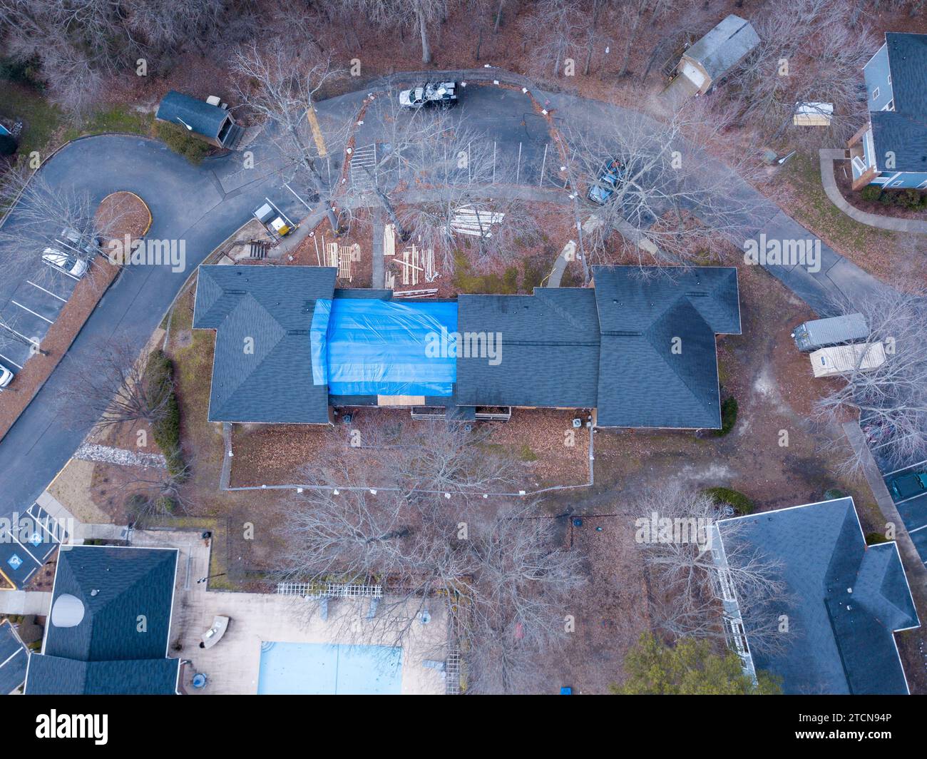 drone images of a fire damaged apartment building with a large tarp ...