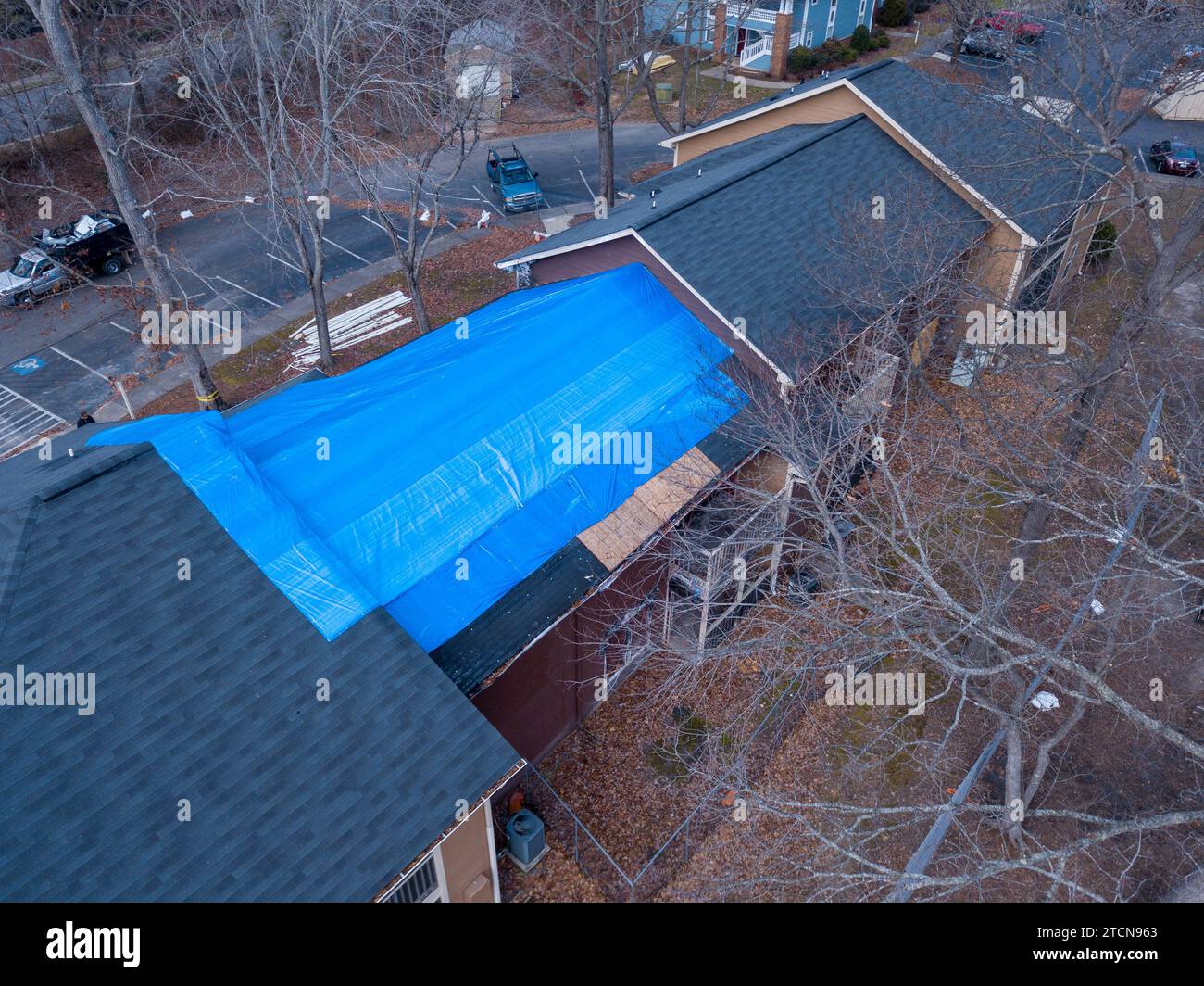 drone images of a fire damaged apartment building with a large tarp ...