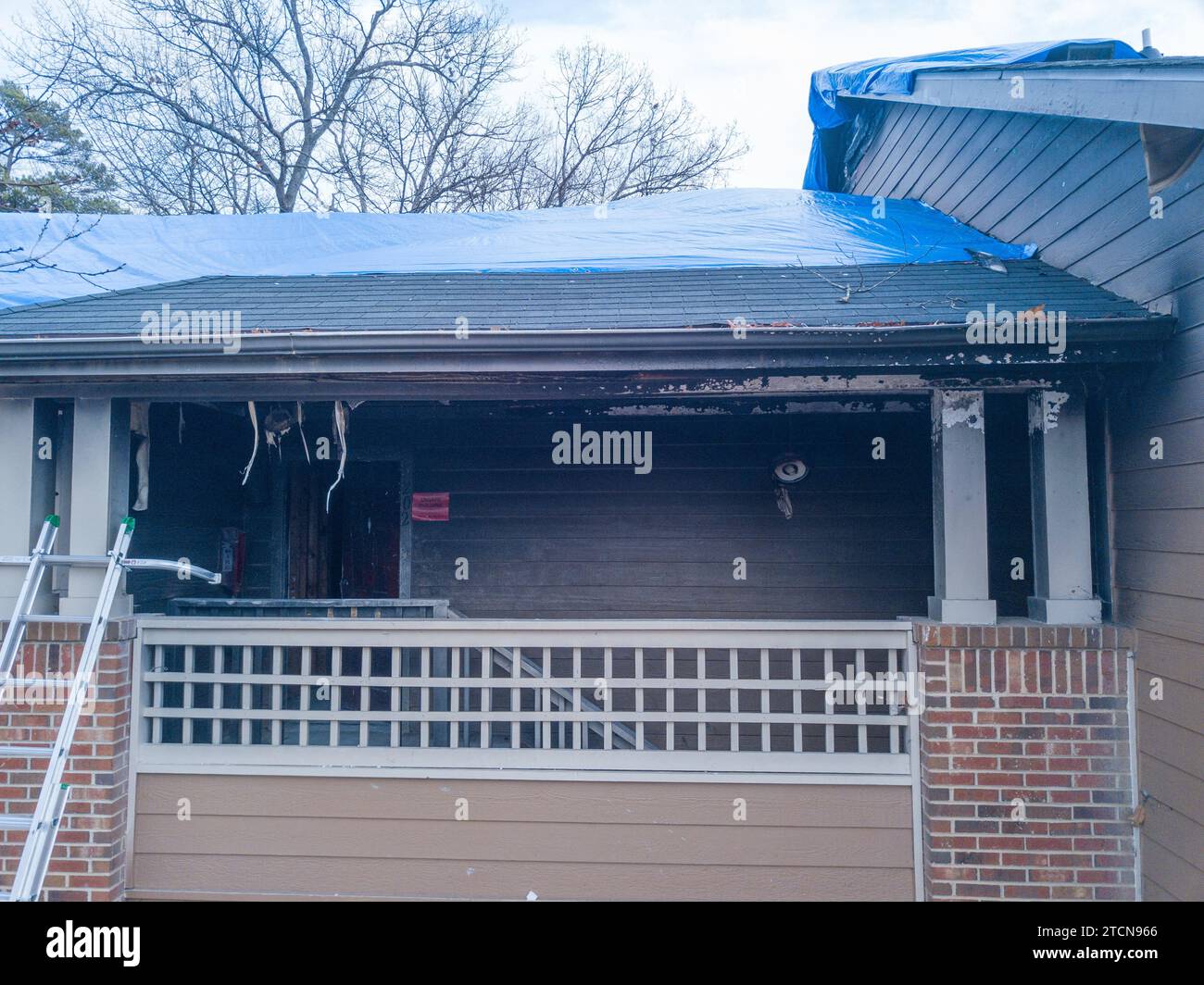 drone images of a fire damaged apartment building with a large tarp ...