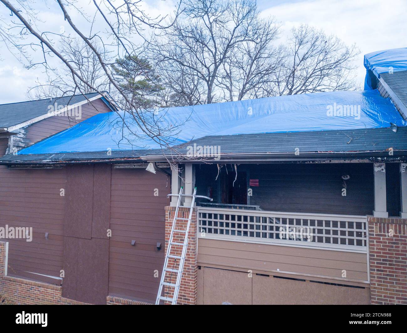 drone images of a fire damaged apartment building with a large tarp ...