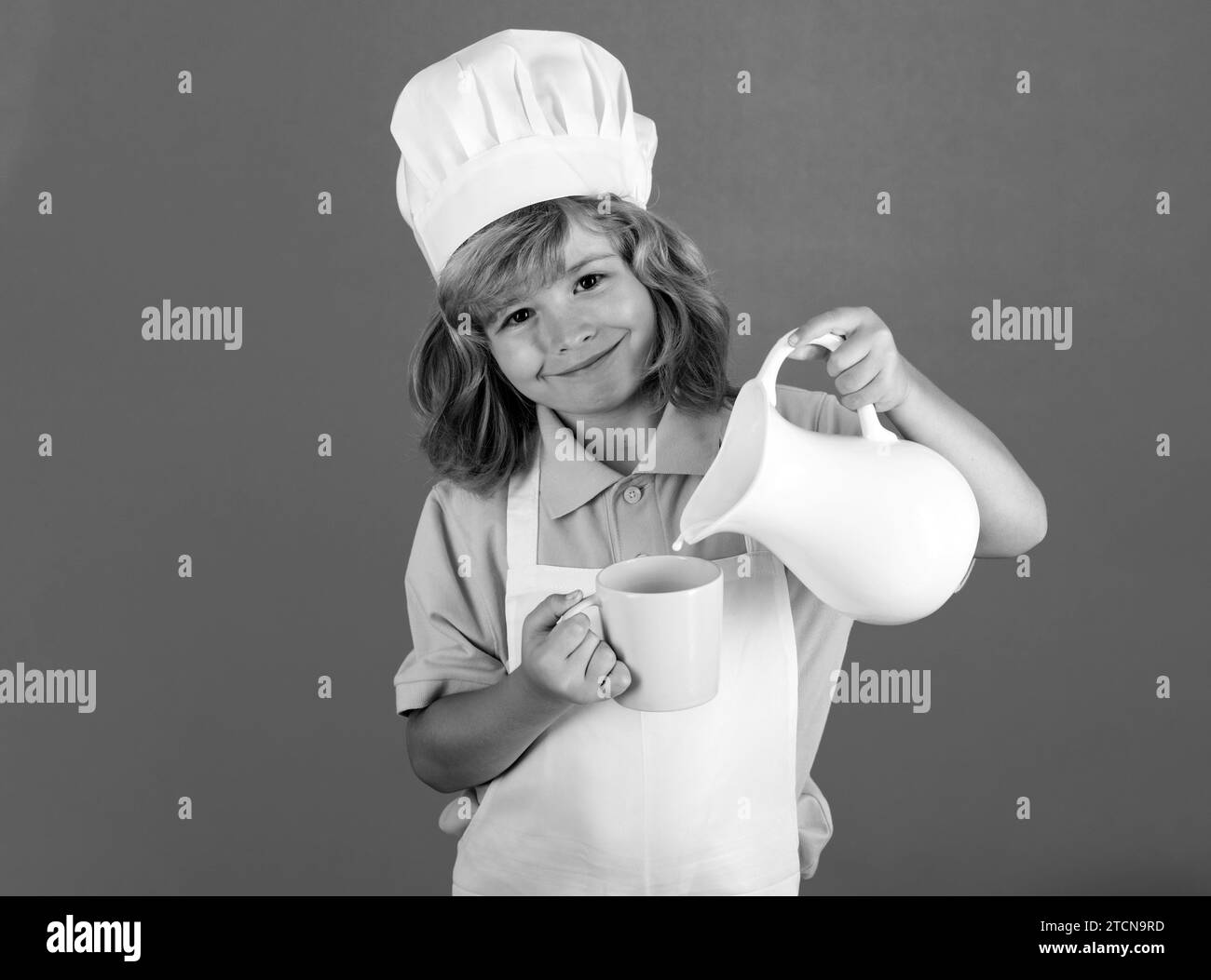Milk for children. Child chef cook prepares food in isolated blue ...