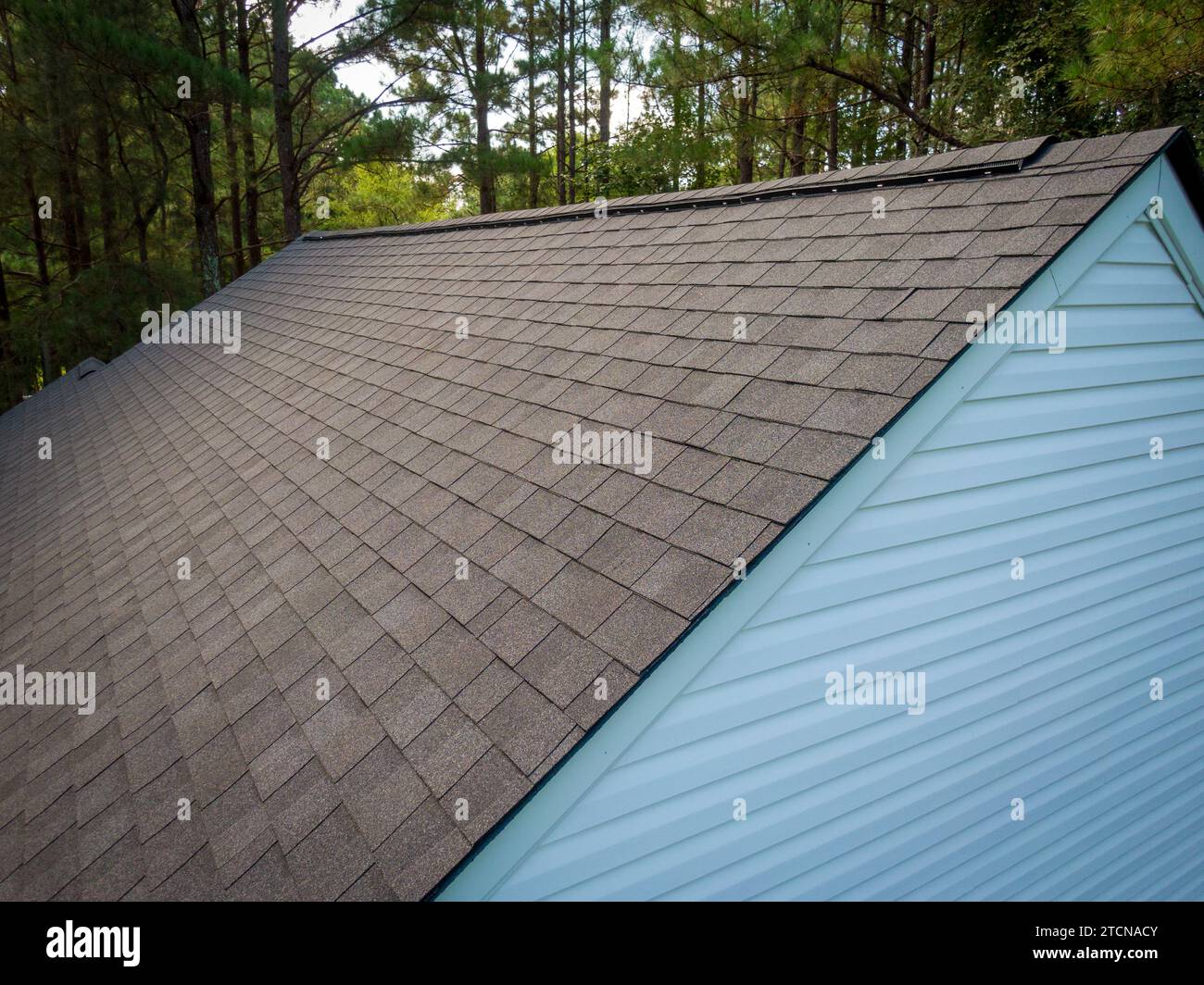 drone photos of a new roof after installation on a wooded lot with lots ...