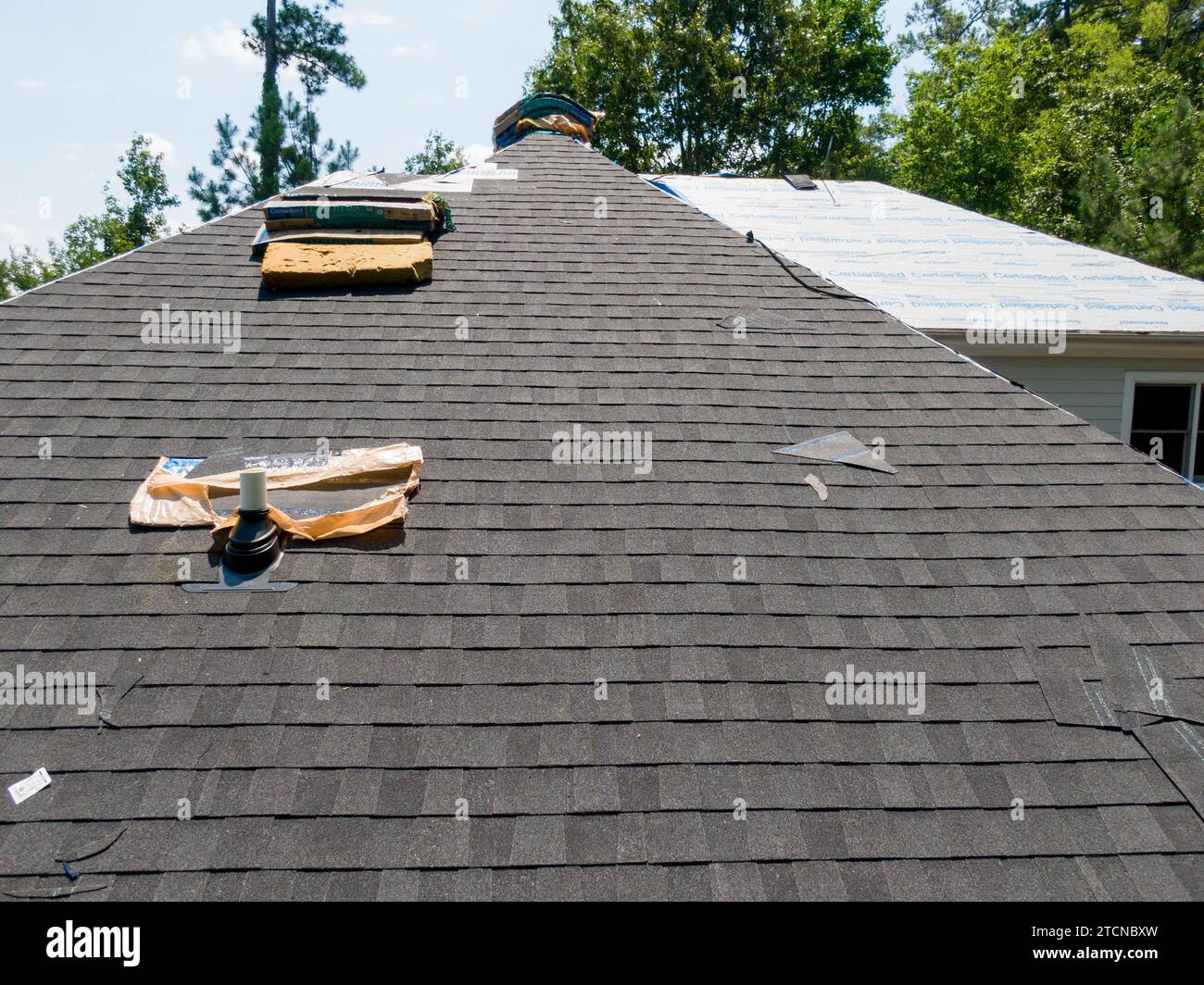 drone images during a large residential roof installation on a bright ...