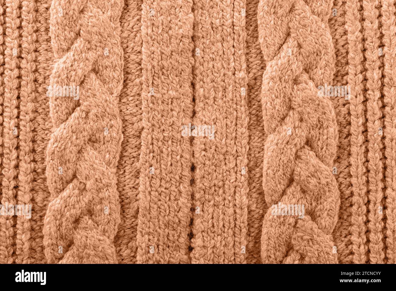 Knitted texture toned with color of the year 2024 peach fuzz, woolen ...