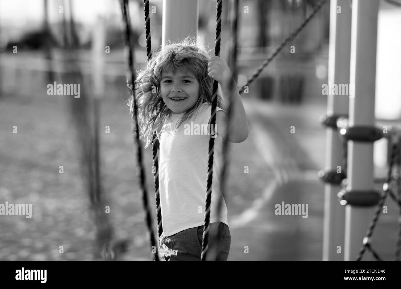 Kids play and climb outdoors on sunny summer day. Child boy playing at ...