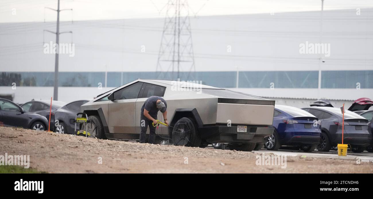 Austin, TX, USA. 13th Dec, 2023. A workman washes a newTesla Cybertruck ...