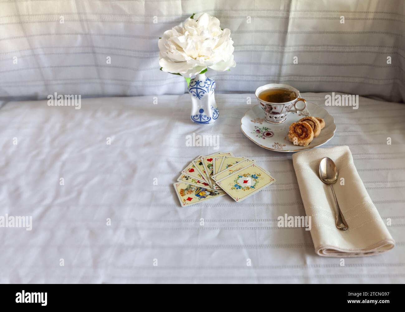 The perfect bridge card hand with a cup of tea and cookies Stock Photo ...
