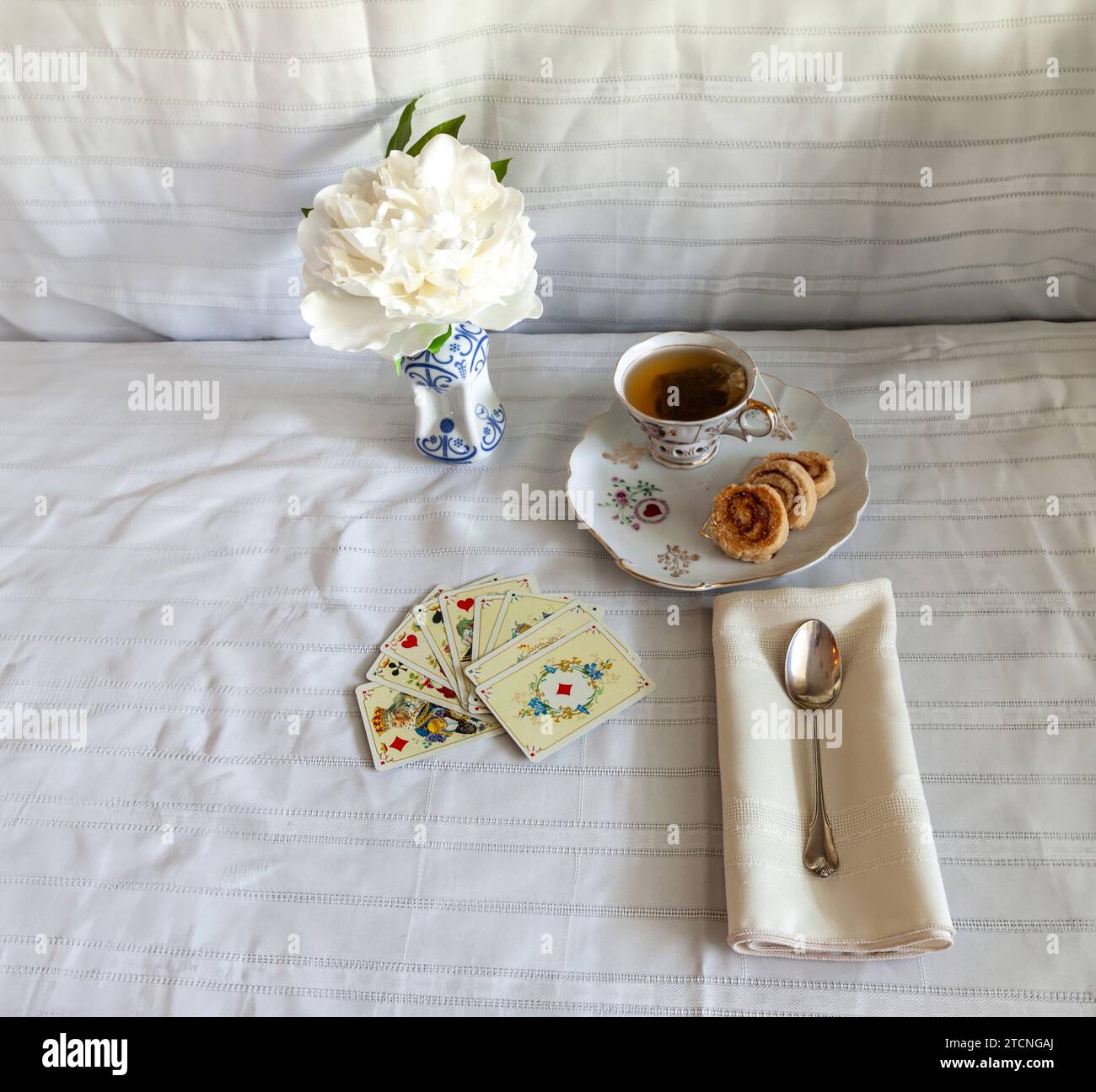 The perfect bridge card hand with a cup of tea and cookies Stock Photo ...