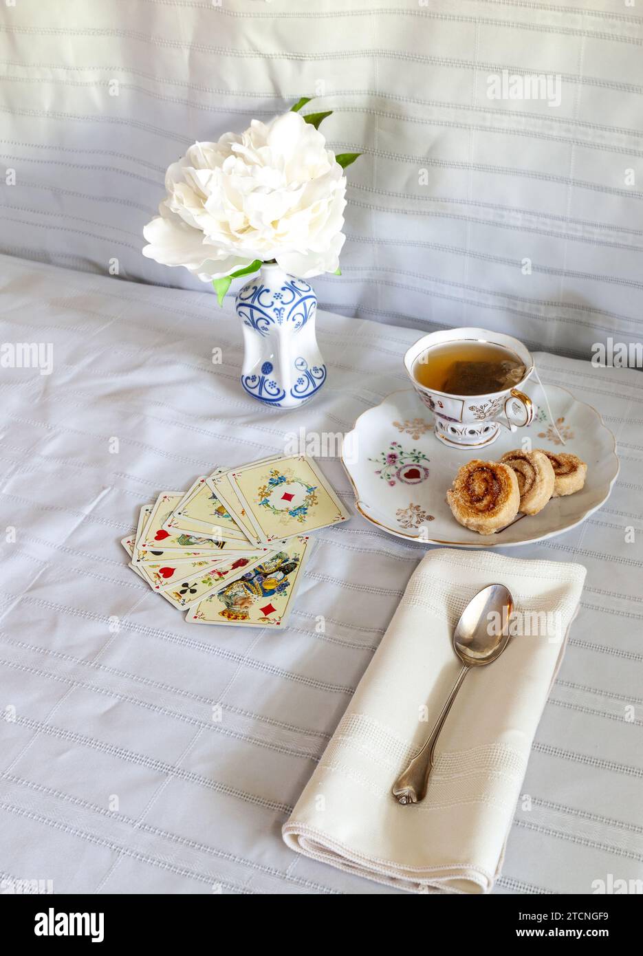 The perfect bridge card hand with a cup of tea and cookies Stock Photo ...