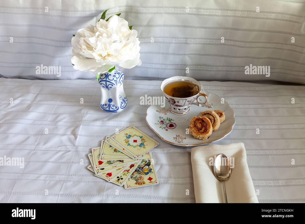 The perfect bridge card hand with a cup of tea and cookies Stock Photo ...
