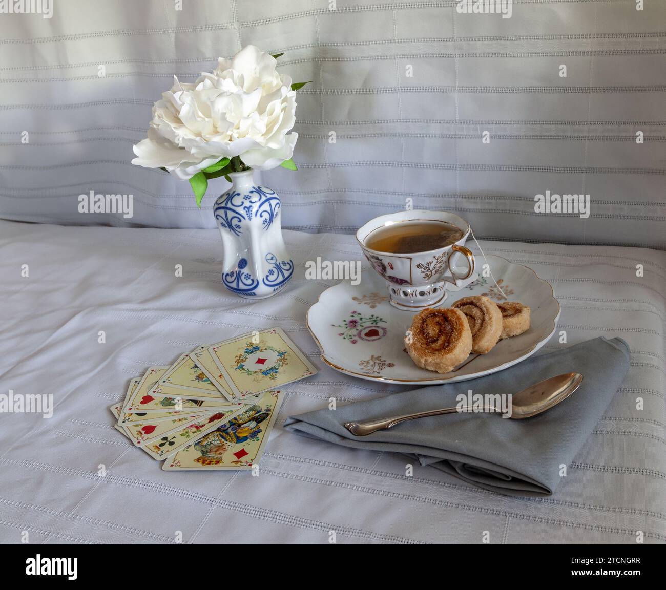 The perfect bridge card hand with a cup of tea and cookies Stock Photo ...