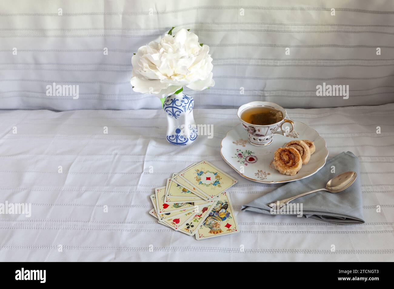 The perfect bridge card hand with a cup of tea and cookies Stock Photo ...