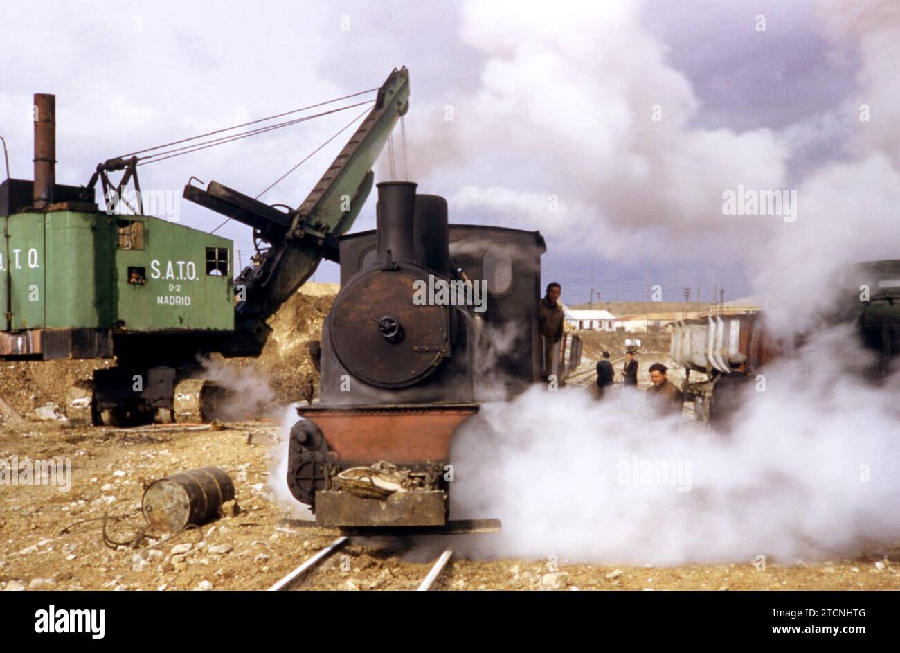 MADRID, SPAIN - 1954: General view of steam locomotive with a backhoe ...