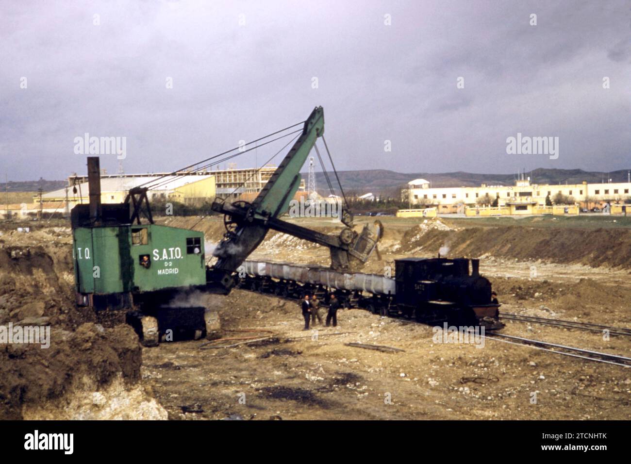 MADRID, SPAIN - 1954: General view of steam locomotive with a backhoe ...
