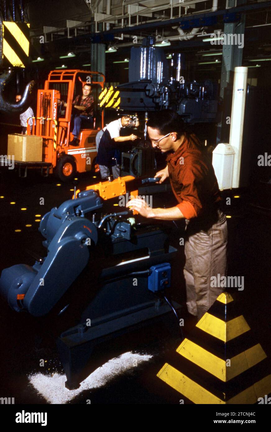 1950'S: General view of an unidentifed man driving his fork lift and ...
