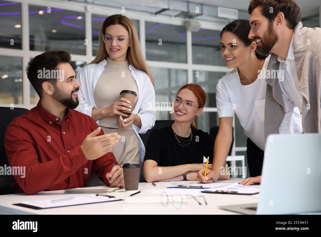Team of employees working together in office Stock Photo - Alamy